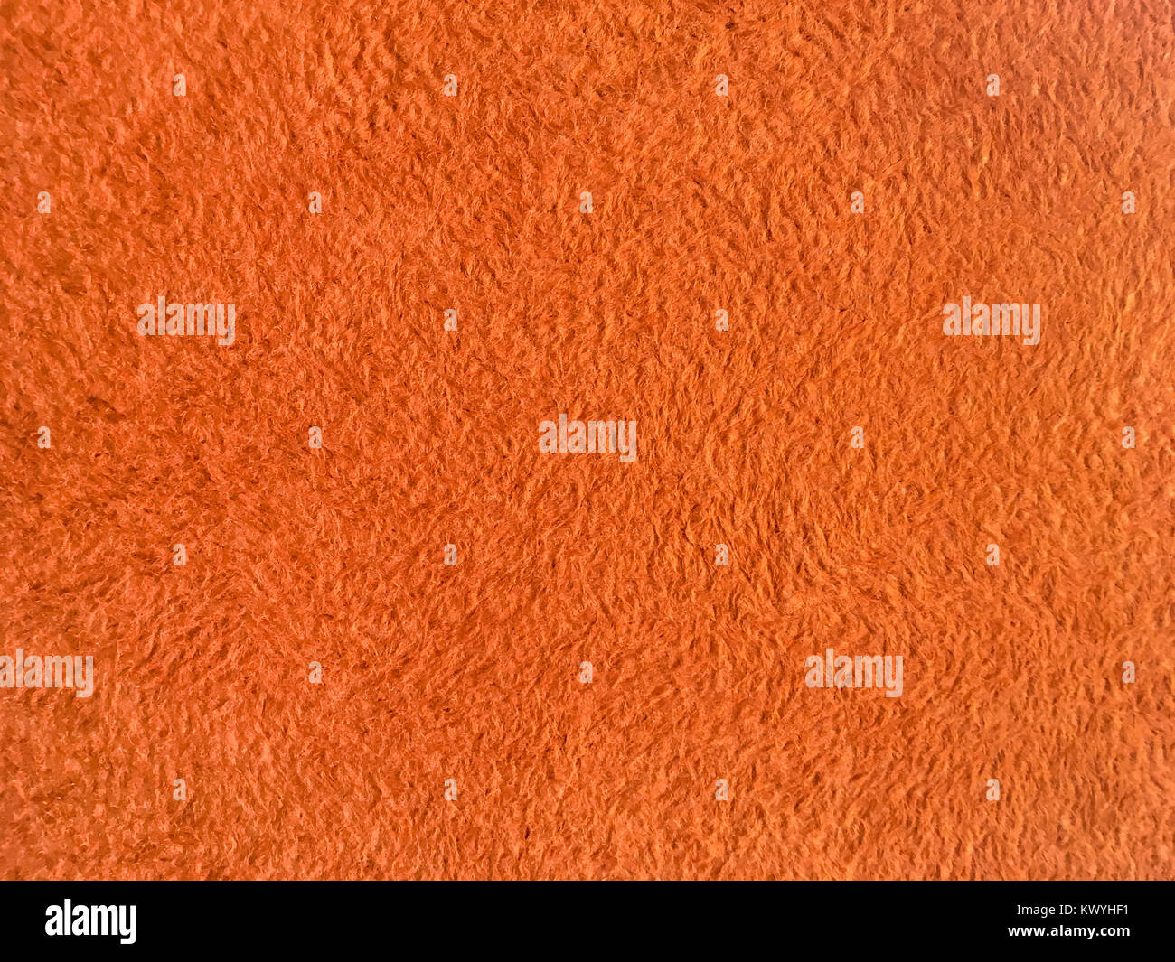 Texture of orange plush wallpaper with a pattern. Textile surface ...