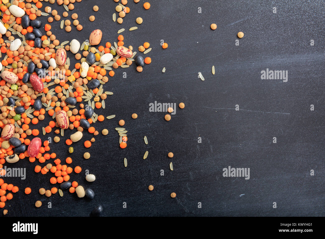 Various raw legumes on black background Stock Photo - Alamy