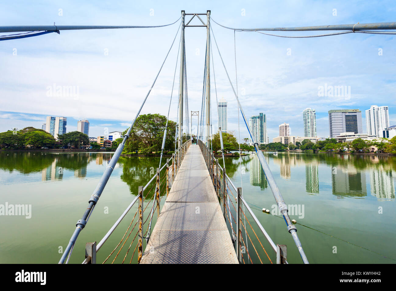 Pedestrian bridge to Gangaramaya public park and Colombo city skyline ...