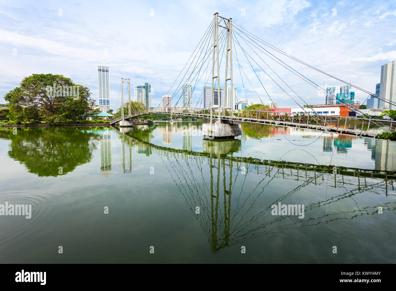 Pedestrian bridge to Gangaramaya public park and Colombo city skyline ...