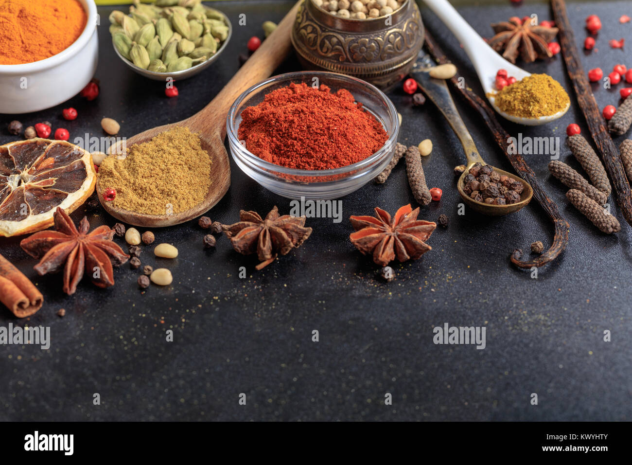 Composition of various spices on a black background Stock Photo - Alamy