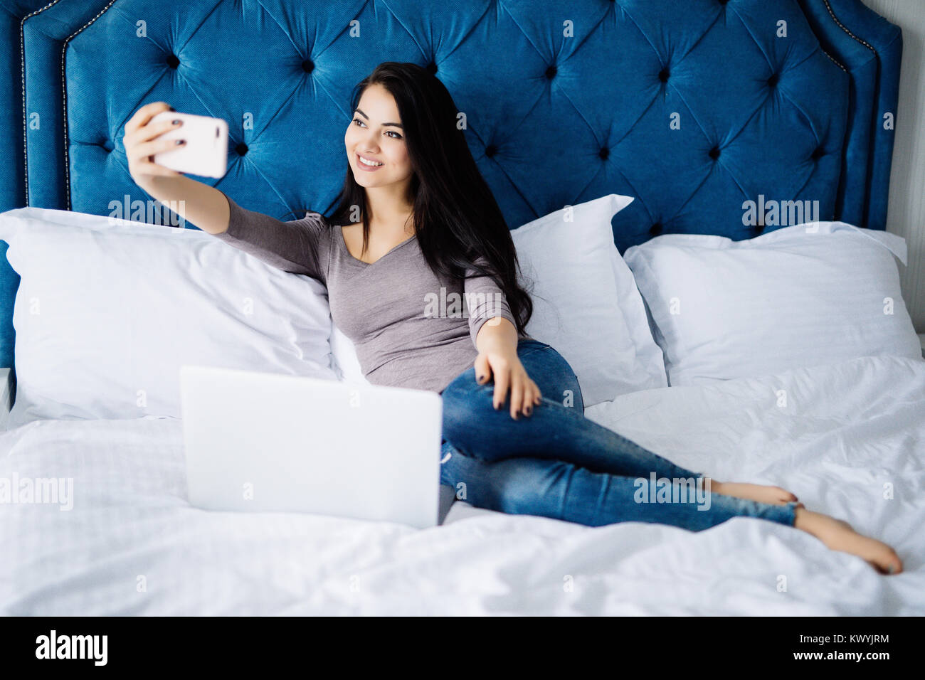 woman taking selfie in bed with laptop Stock Photo - Alamy