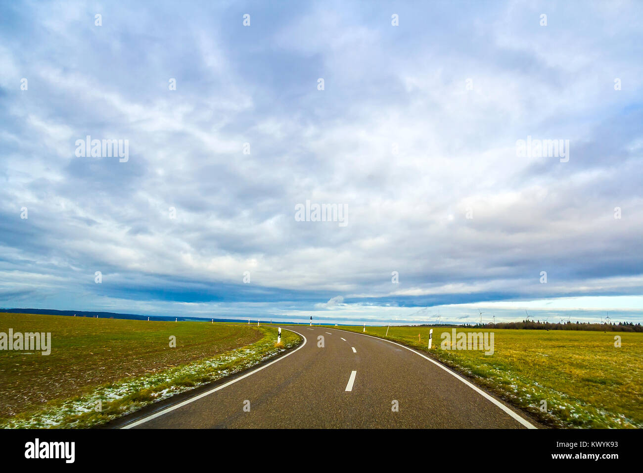 Empty black asphalt road between green fields Stock Photo - Alamy