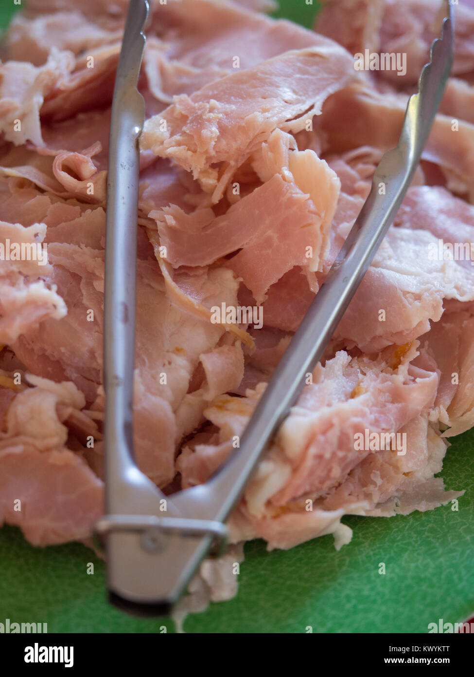 Shaved Ham And Serving Tongs Stock Photo - Alamy