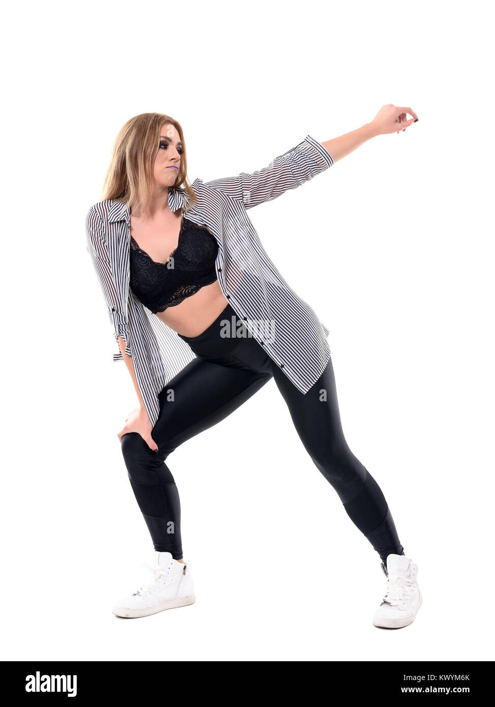 Funky woman jazz dancer dancing pose with one arm on knee and other ...