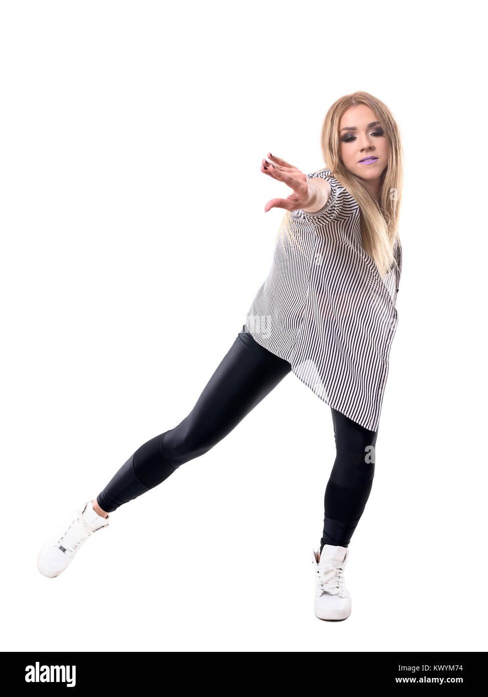 Graceful jazz dancing woman moving elegantly wearing striped shirt and ...