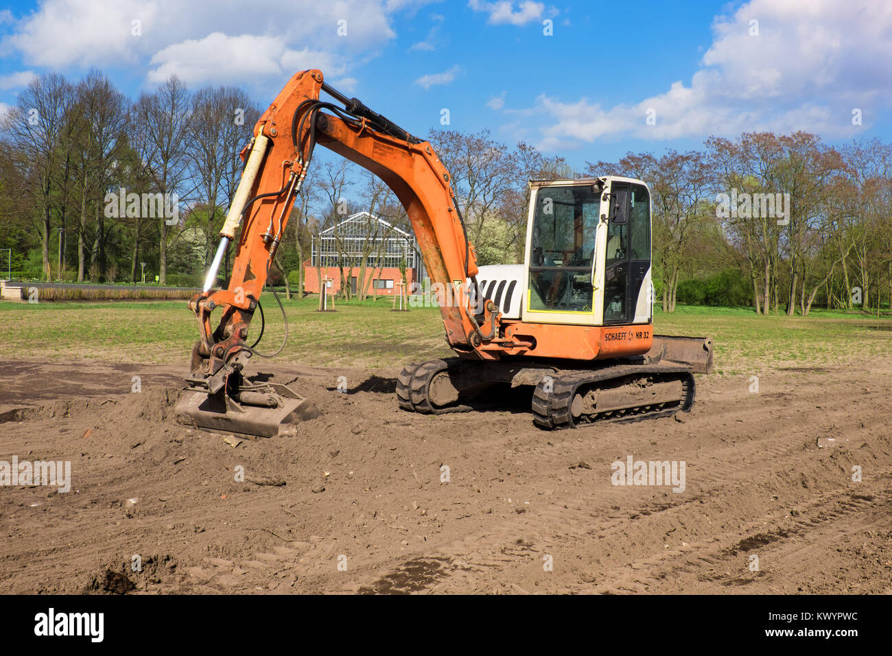 BERLIN, GERMANY - APRIL 4, 2016: middle-sized orange excavator on a ...