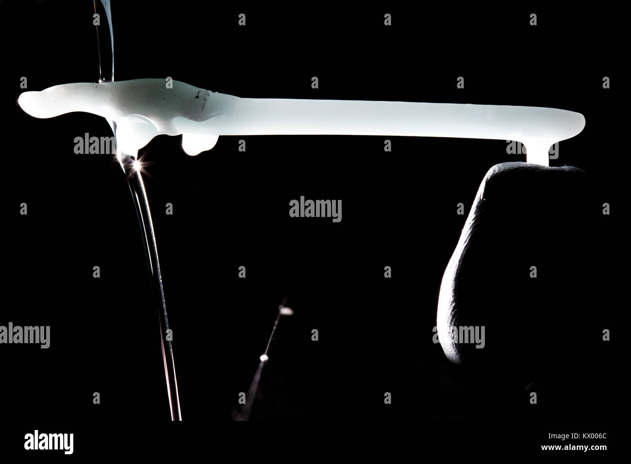 Dripping wax on a wax stick on a plain black background Stock Photo - Alamy