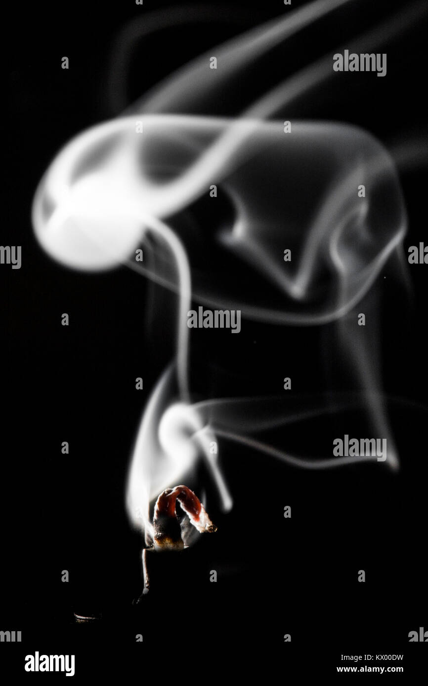 Smoke coming from extinguished wick on a plain black backrground Stock ...