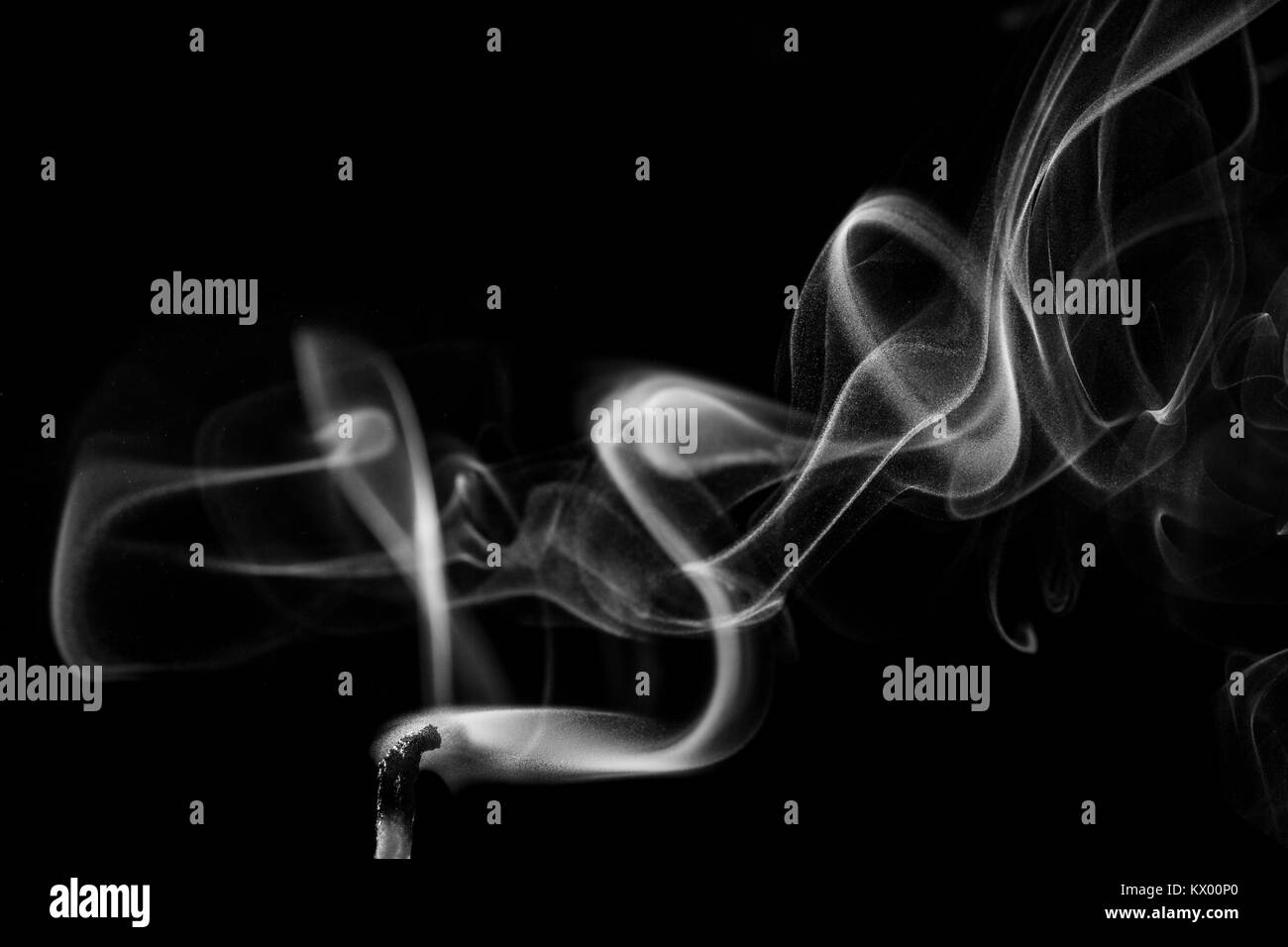 Smoke coming from extinguished wick on a plain black backrground Stock ...