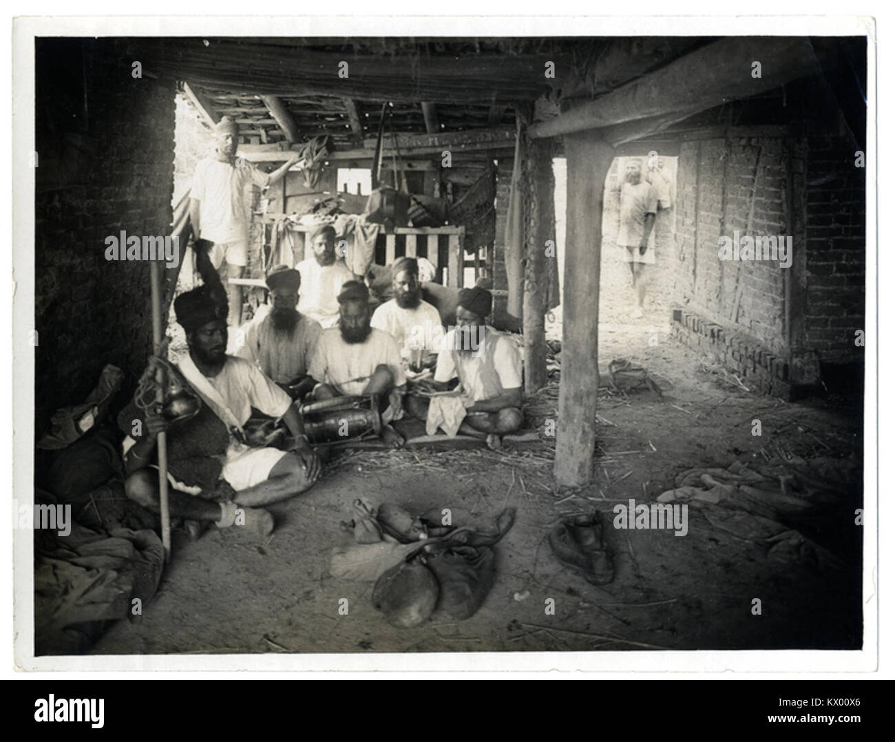 Photograph showing Sikhs performing religious chants inside a barn in ...