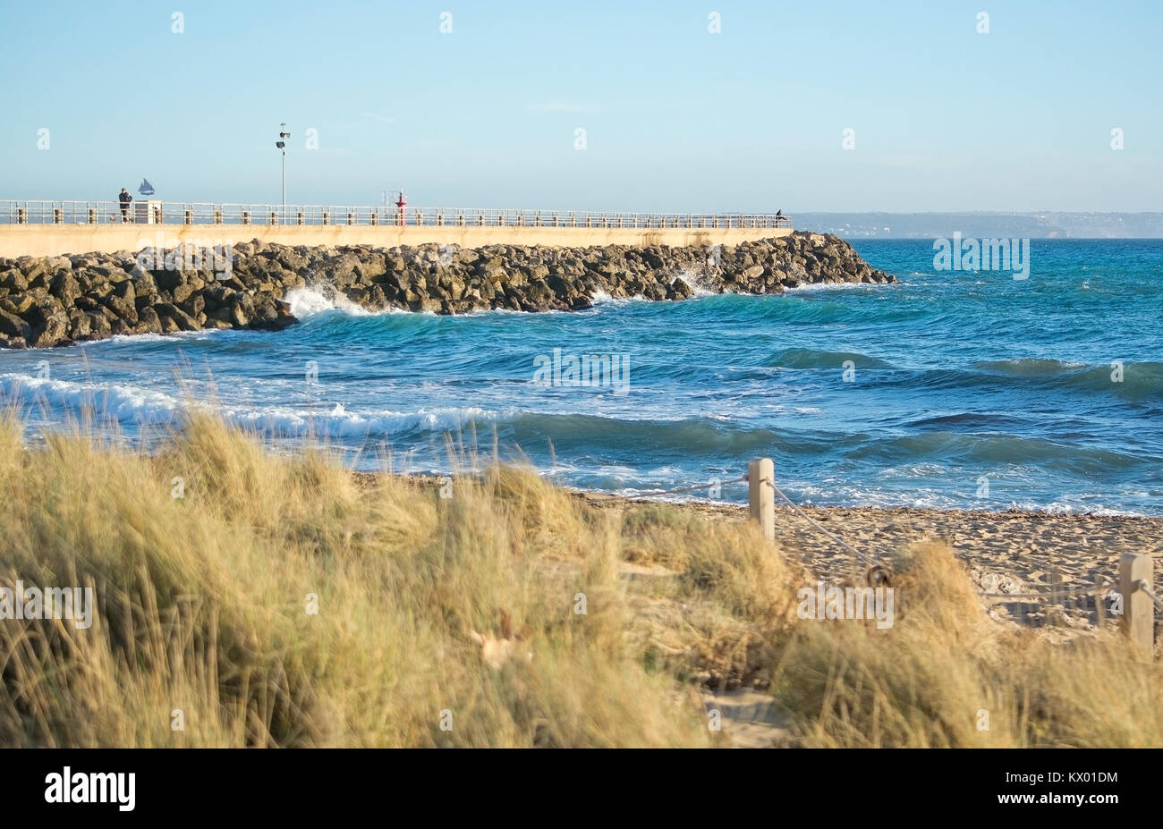 PALMA DE MALLORCA, SPAIN - JANUARY 4, 2018: Portixol pier beach grass ...