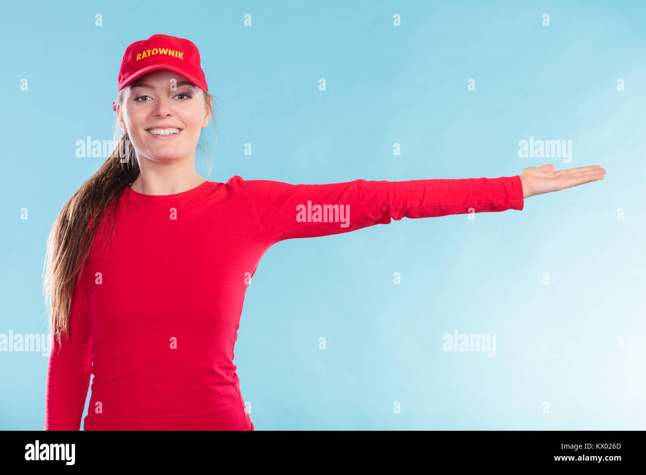 Portrait of happy lifeguard woman girl in red cap with ratownik sign ...