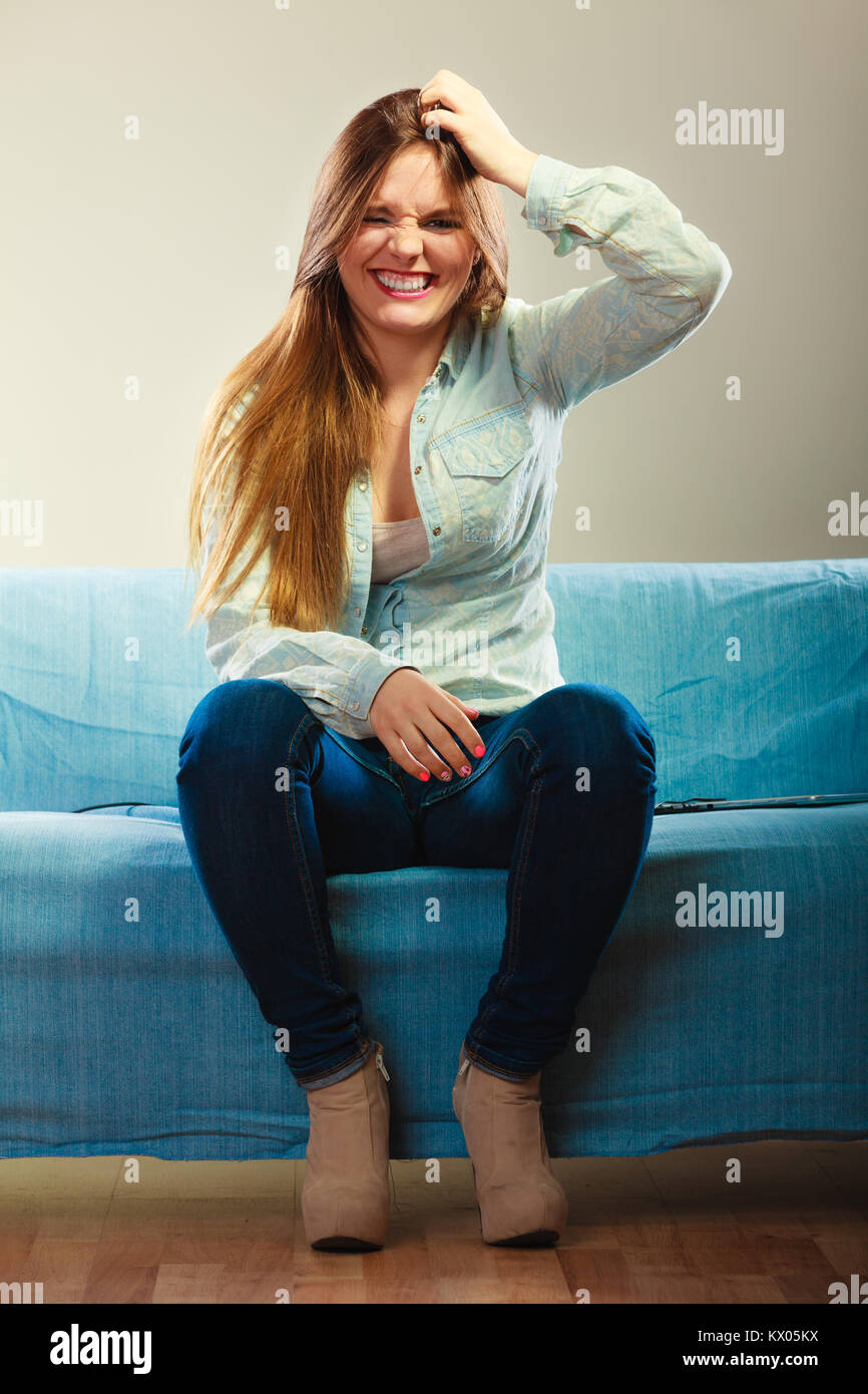 Young people concept - funny long hair girl making silly face sitting ...