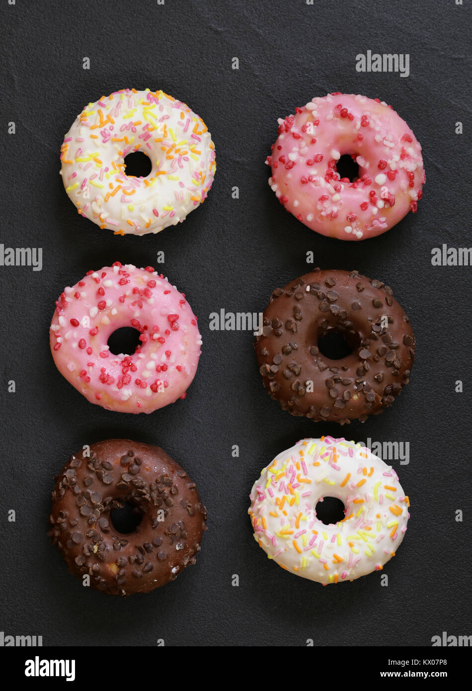 sweet donuts with sugar and chocolate colored glaze Stock Photo - Alamy