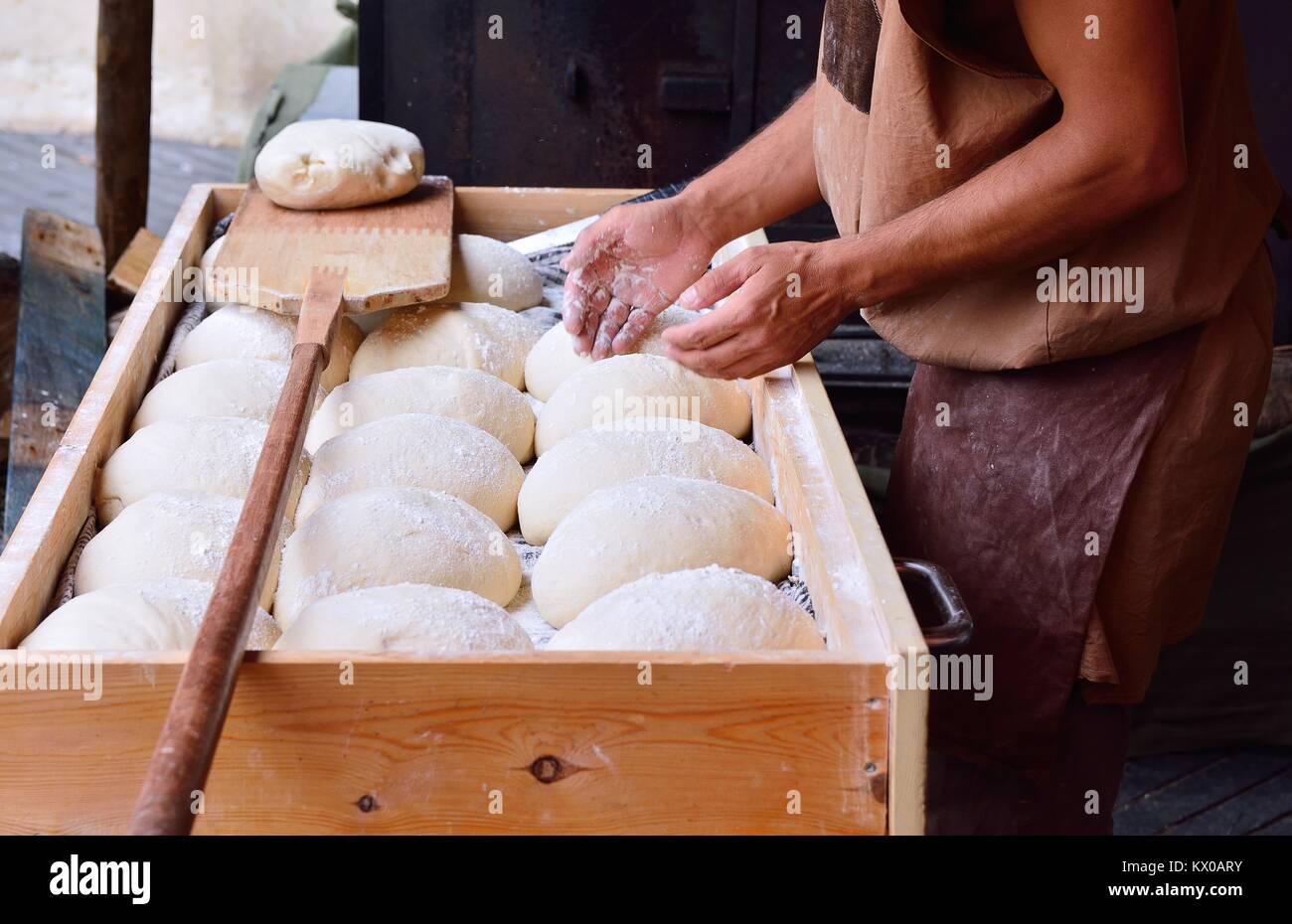 Unrecognizable baker sprinkle bread dough with flour Stock Photo - Alamy