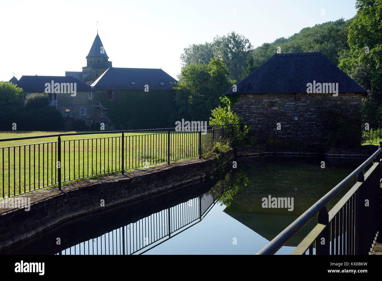 L'HOPITAl ST BLAISE, FRANCE – CIRCA JULY 2015 Pool with fence and old ...