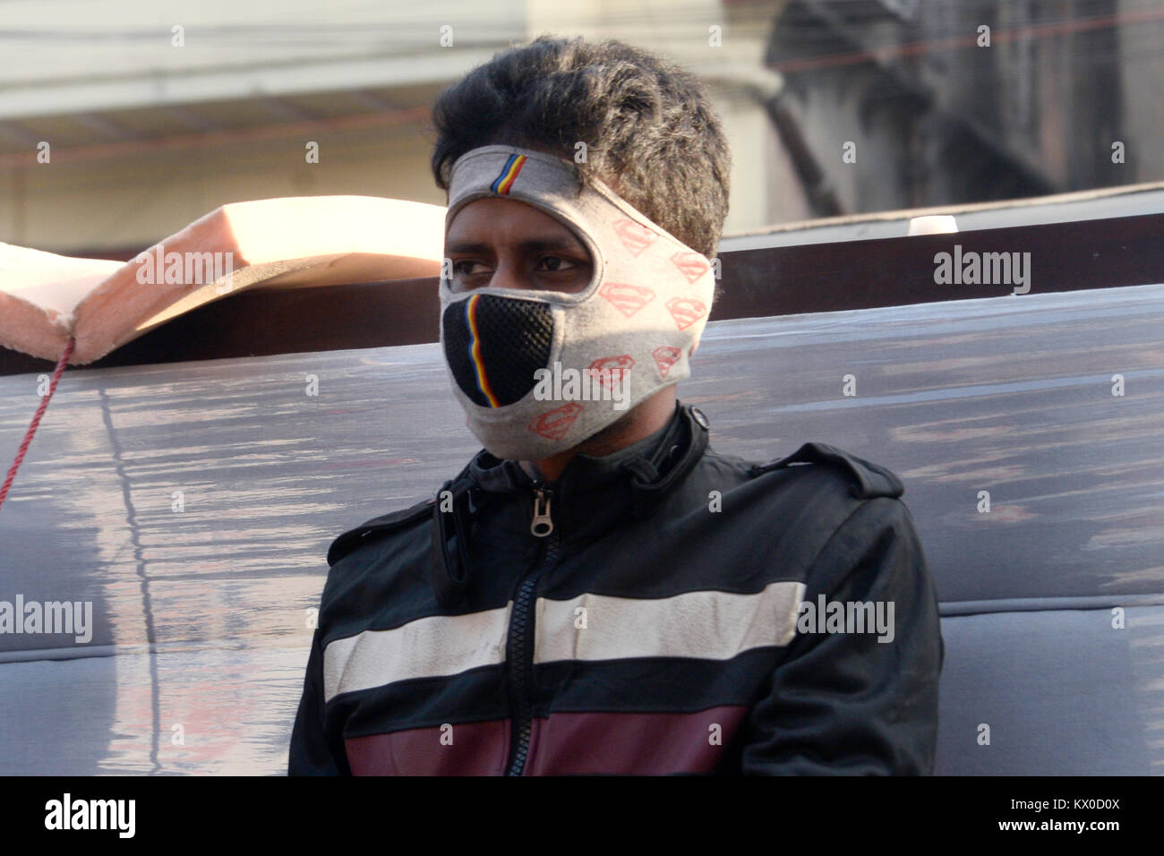Kolkata, India. 05th Jan, 2018. Indian man covers his face with mask to ...