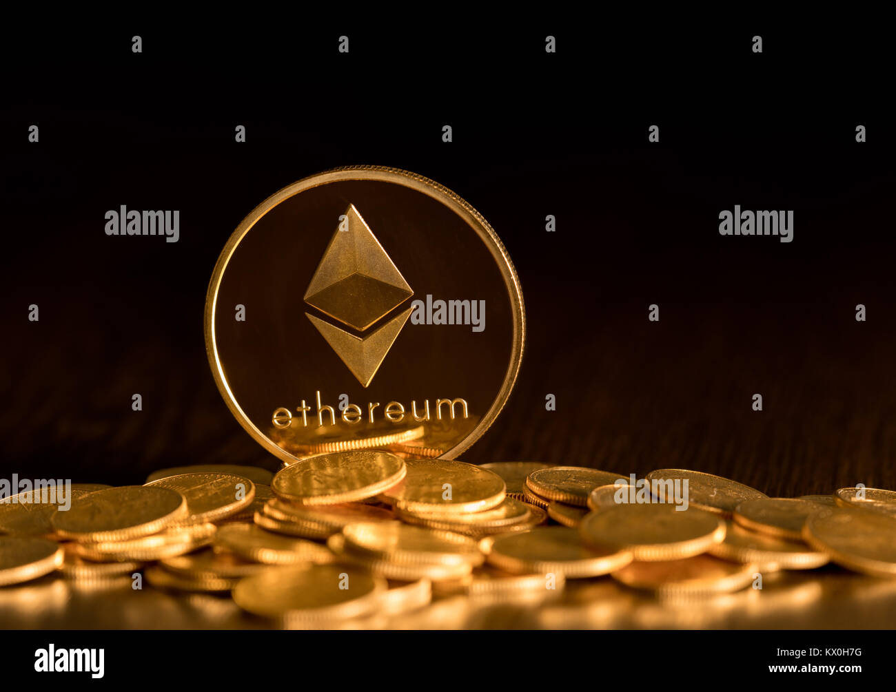 Stack of Ether coins with gold background Stock Photo - Alamy