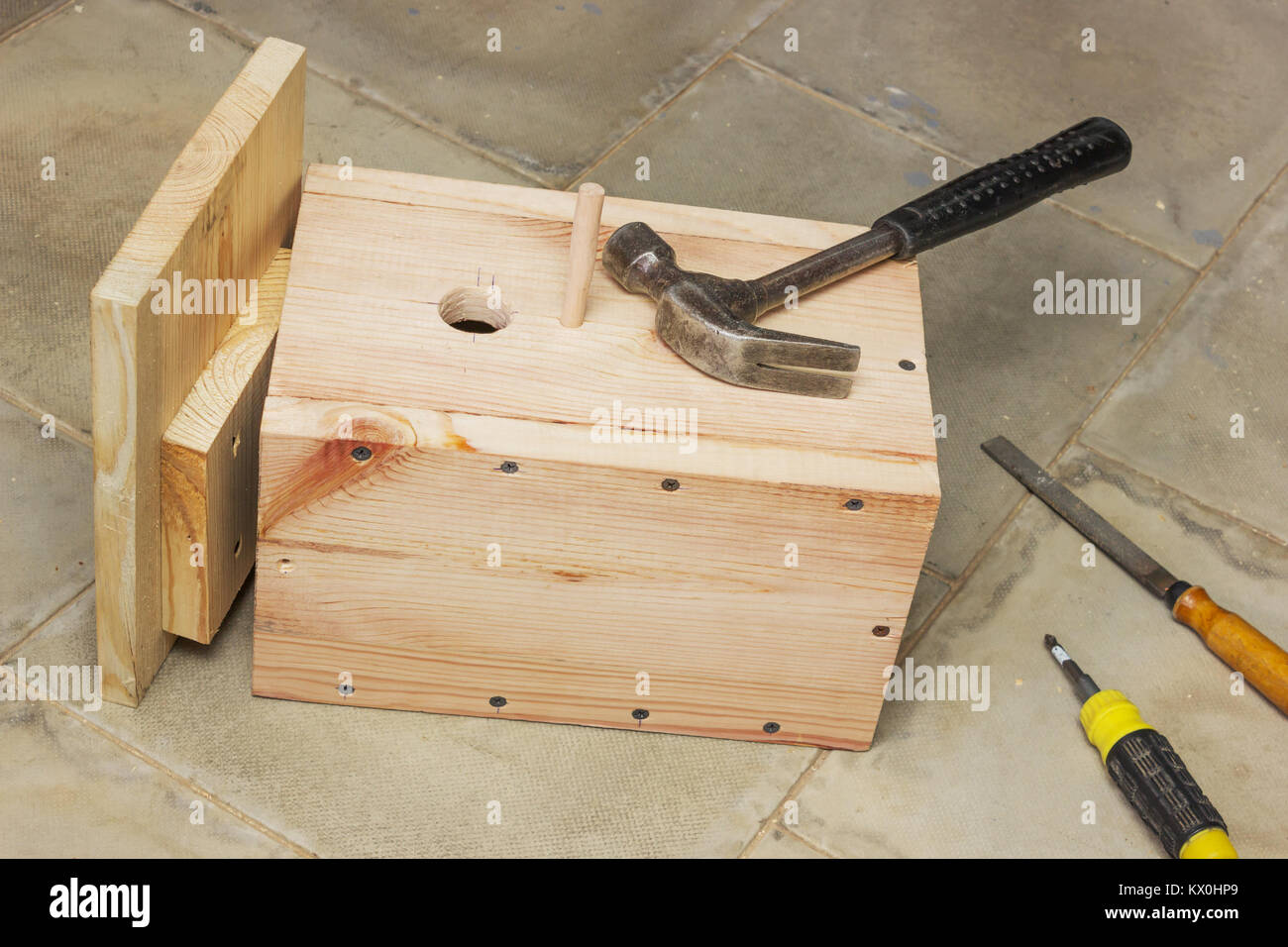 Ready birdhouse and tool lying on the floor in the workshop Stock Photo ...