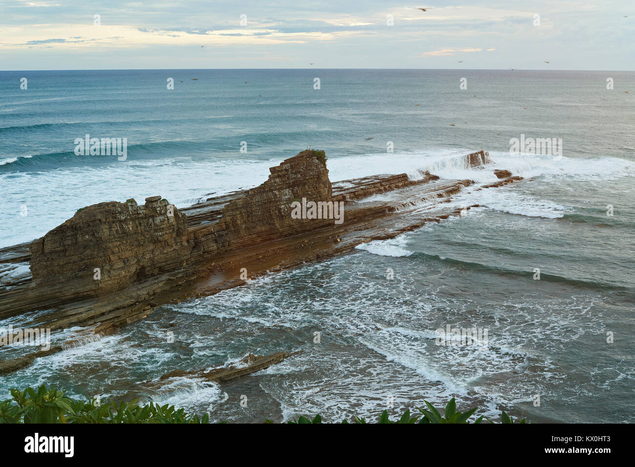 Magnific big rock in ocean on sunset light time Stock Photo - Alamy