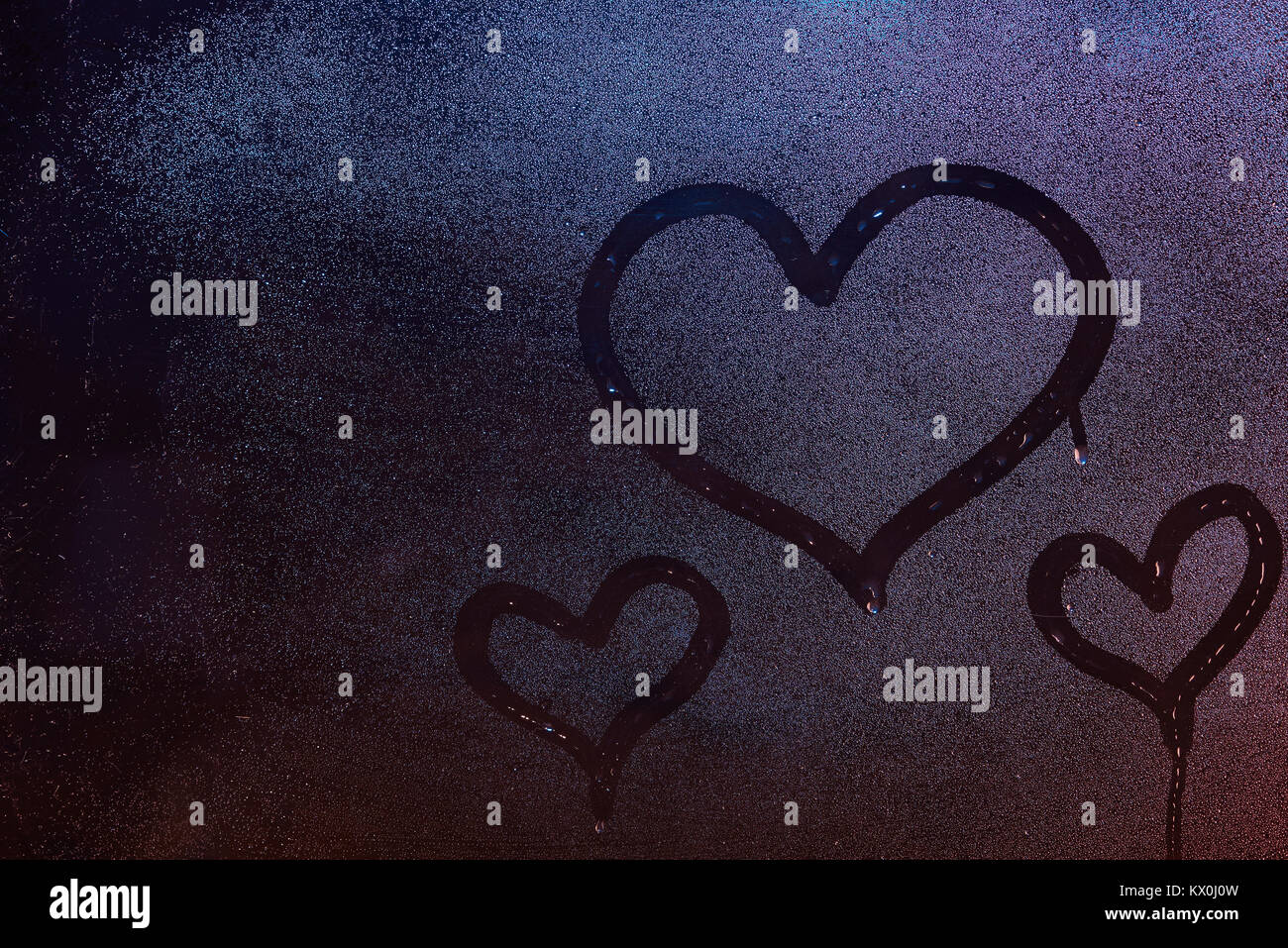 Heart draw on dew window background. Three drawing of hearts on fogged ...