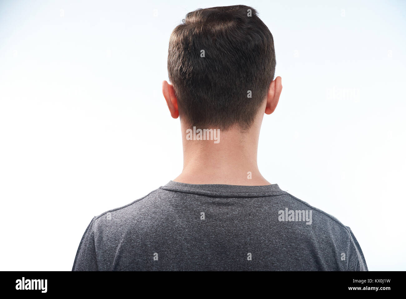 Man in gray shirt back view close-up isolated on white background Stock ...