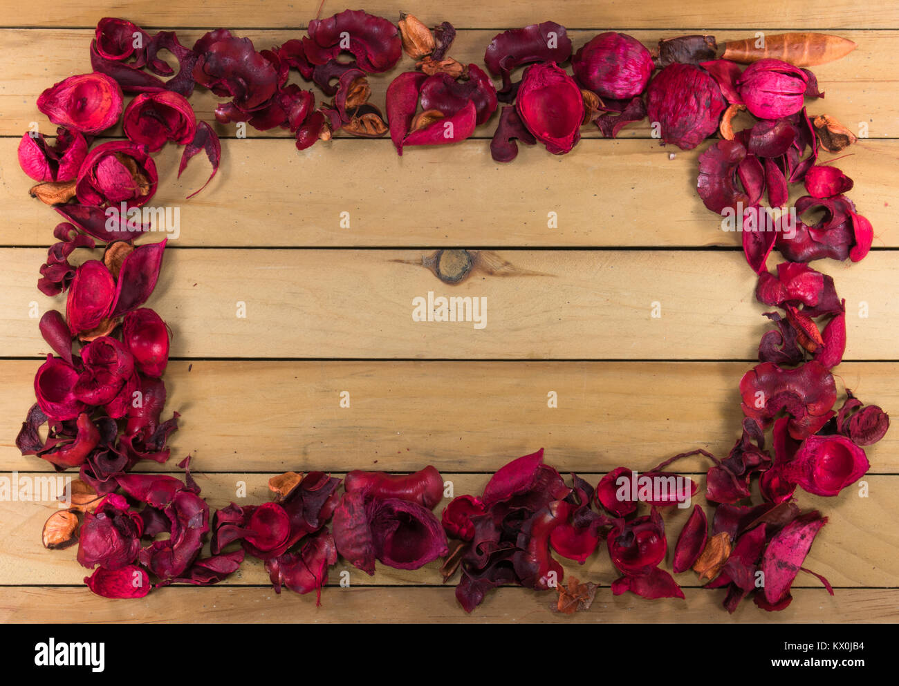 Red potpourri rectangular border on a wood slat background with copy ...