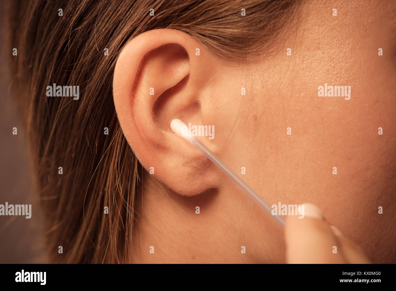 Hygiene concept. Woman cleaning ear with cotton swabs closeup Stock ...