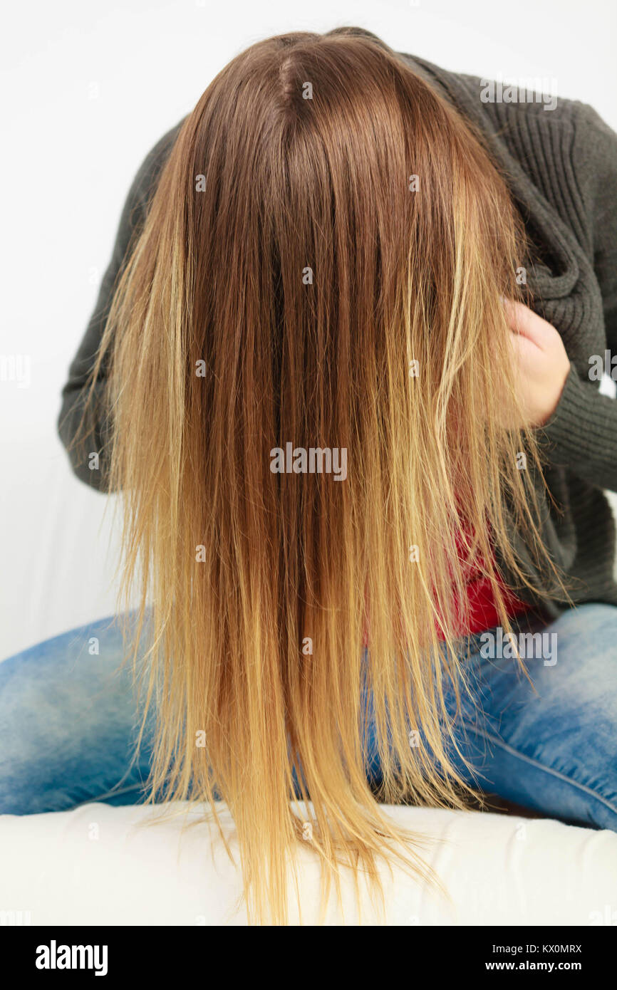 Girl hiding face behind hairs. Young woman with straight long hairs ...