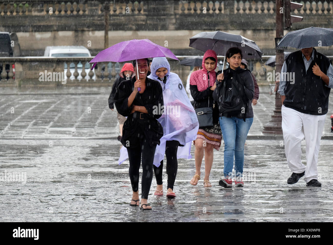 France, Paris, Tourists crossing Place de la Concorde in rain Stock ...