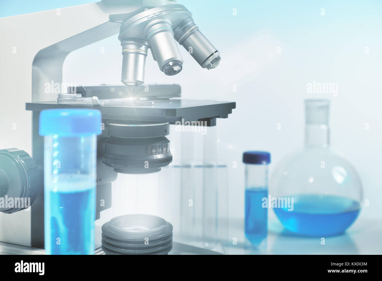 Scientific background with closeup on light microscope and laboratory ...
