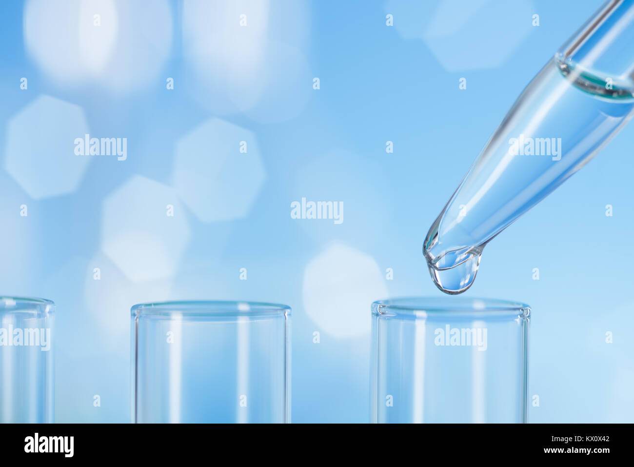 Scientific background: drop from pipette falling in a tube, text space ...