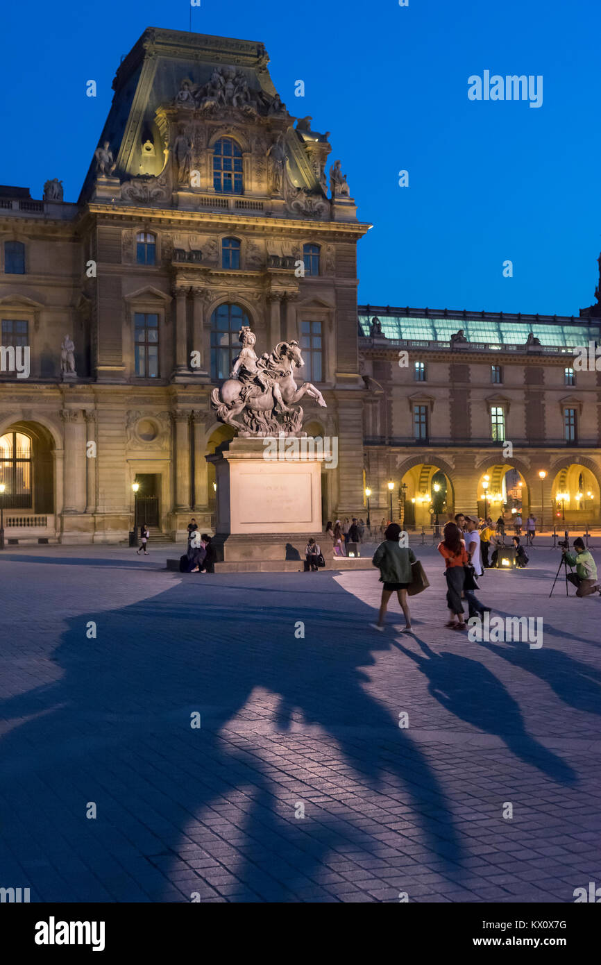 France, Paris (75), Louvre at dusk with the statue of Louis XIV Stock ...
