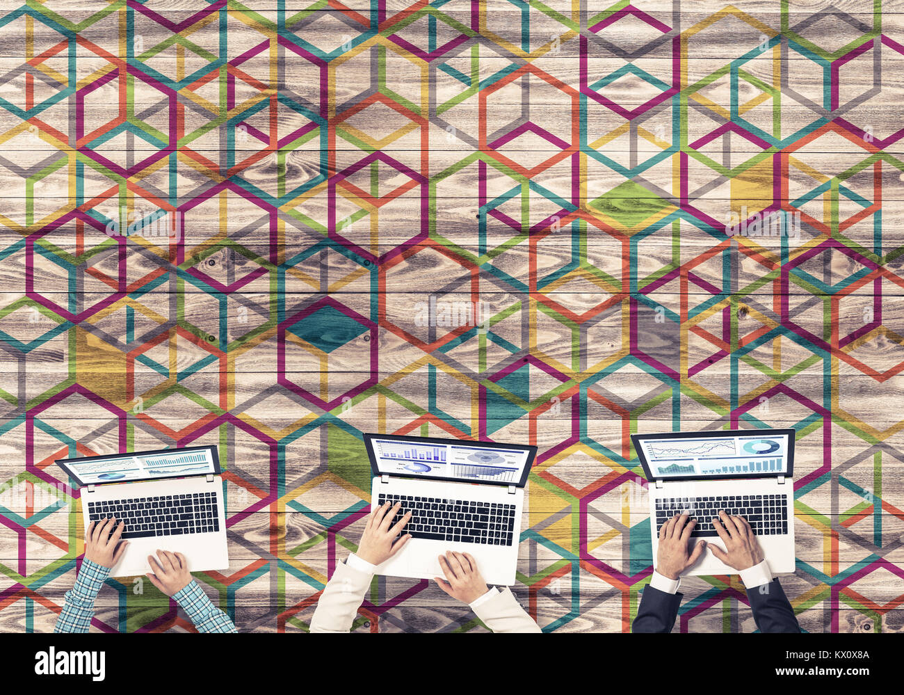 Group of three people with devices in hands working together as symbol ...