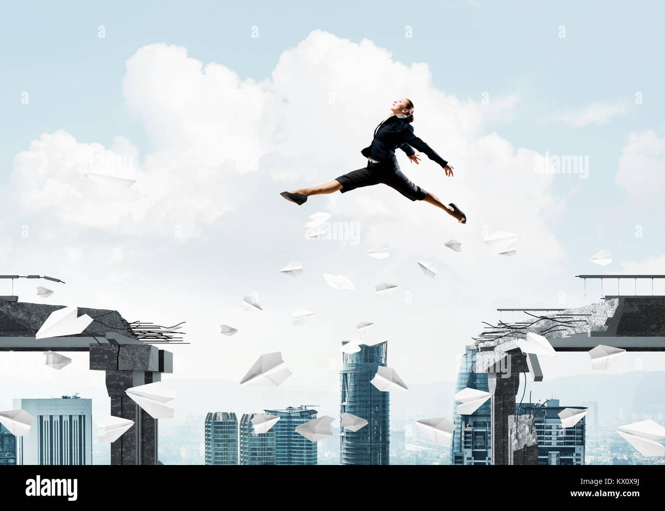 Business woman jumping over gap with flying paper planes in concrete ...
