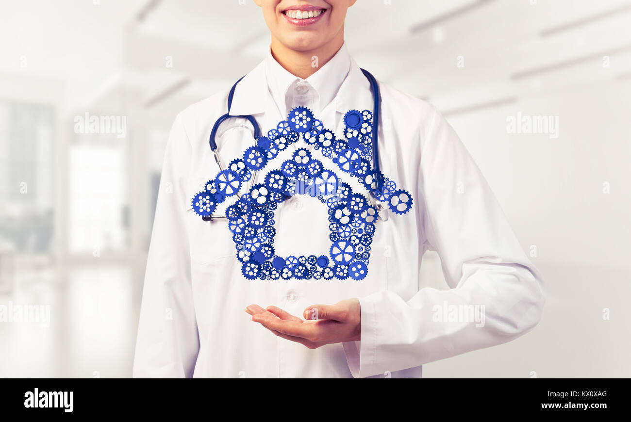 Hand of woman doctor showing house or home gear sign in palm Stock ...