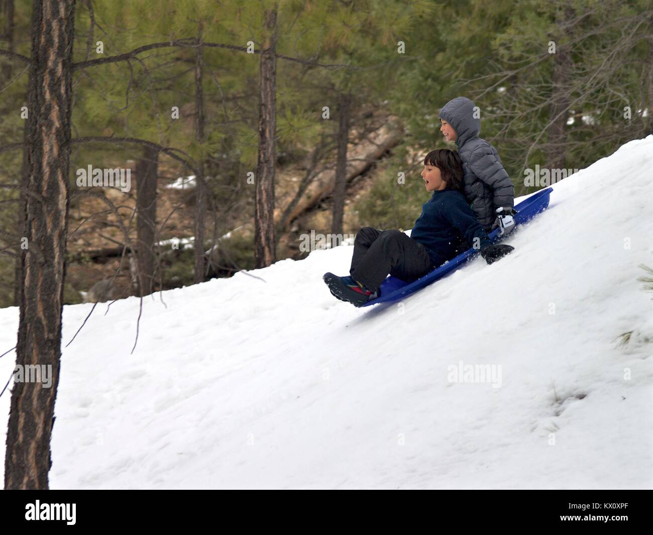 Kid on a sled hi-res stock photography and images - Alamy