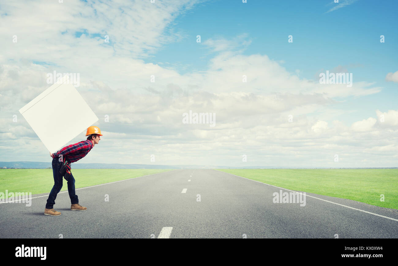 Man carrying on his back large box Stock Photo - Alamy