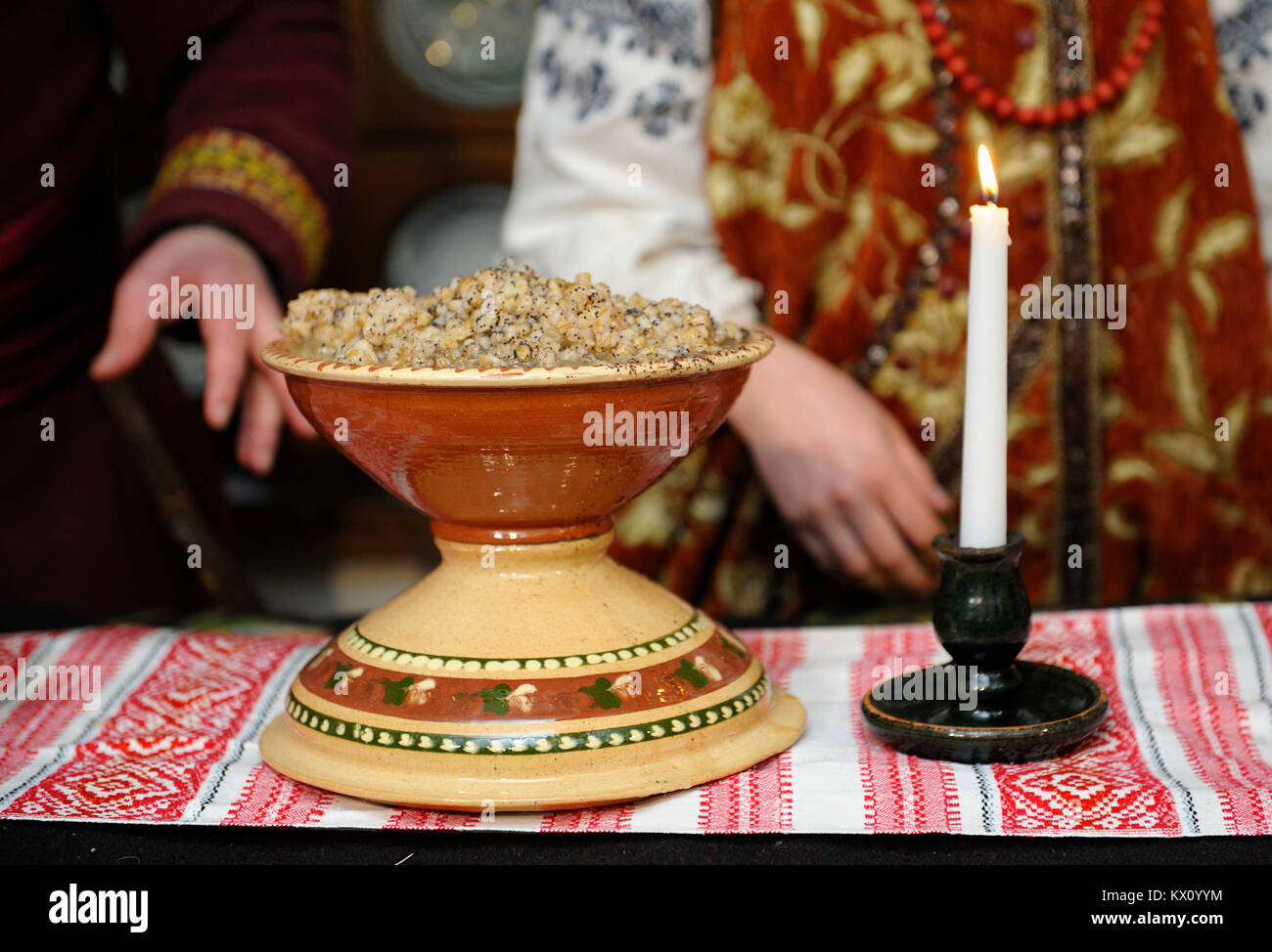 People in Ukrainian native dresses standing behind table to celebrate ...