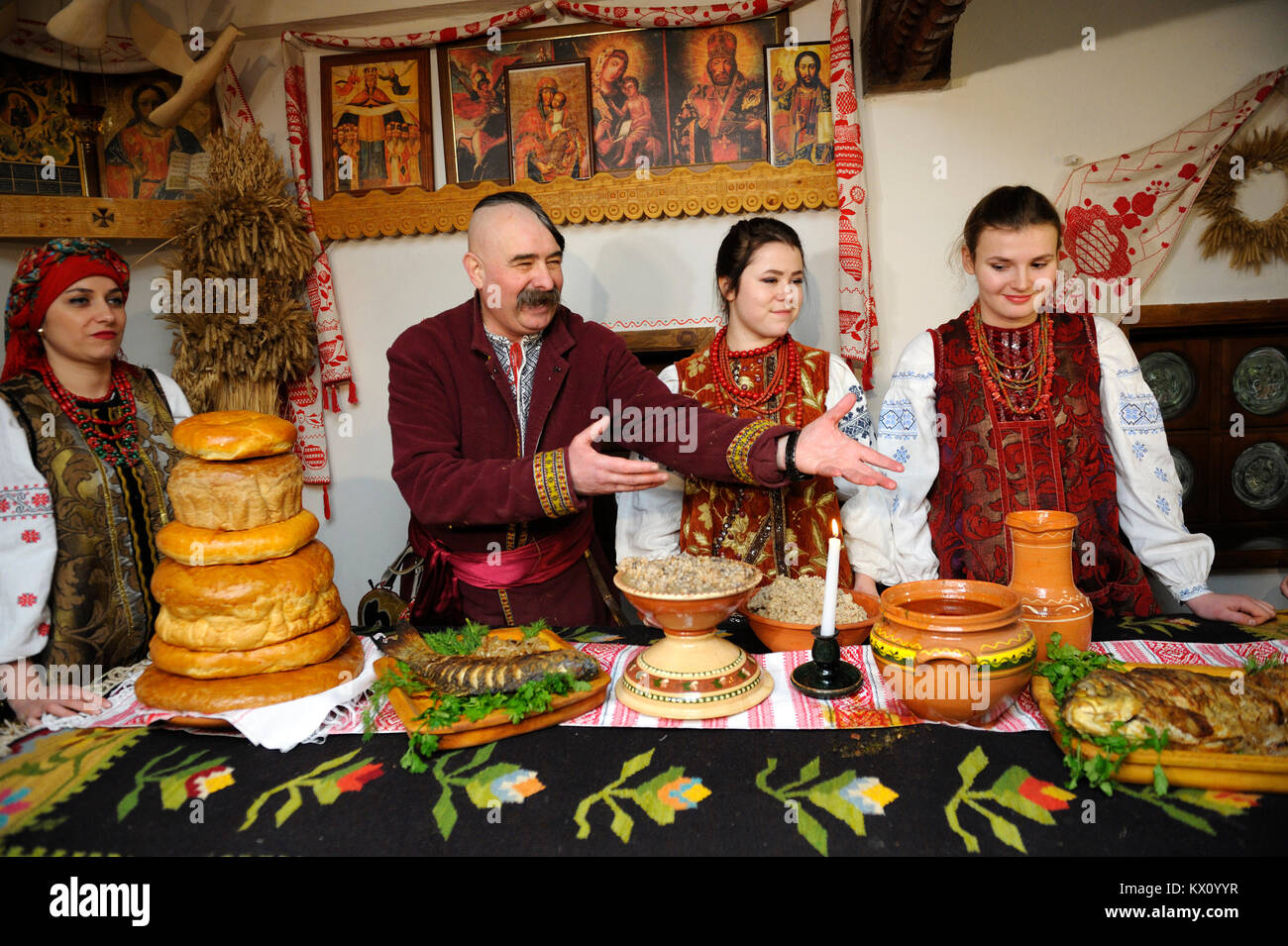 People in Ukrainian native dresses standing behind table to celebrate ...