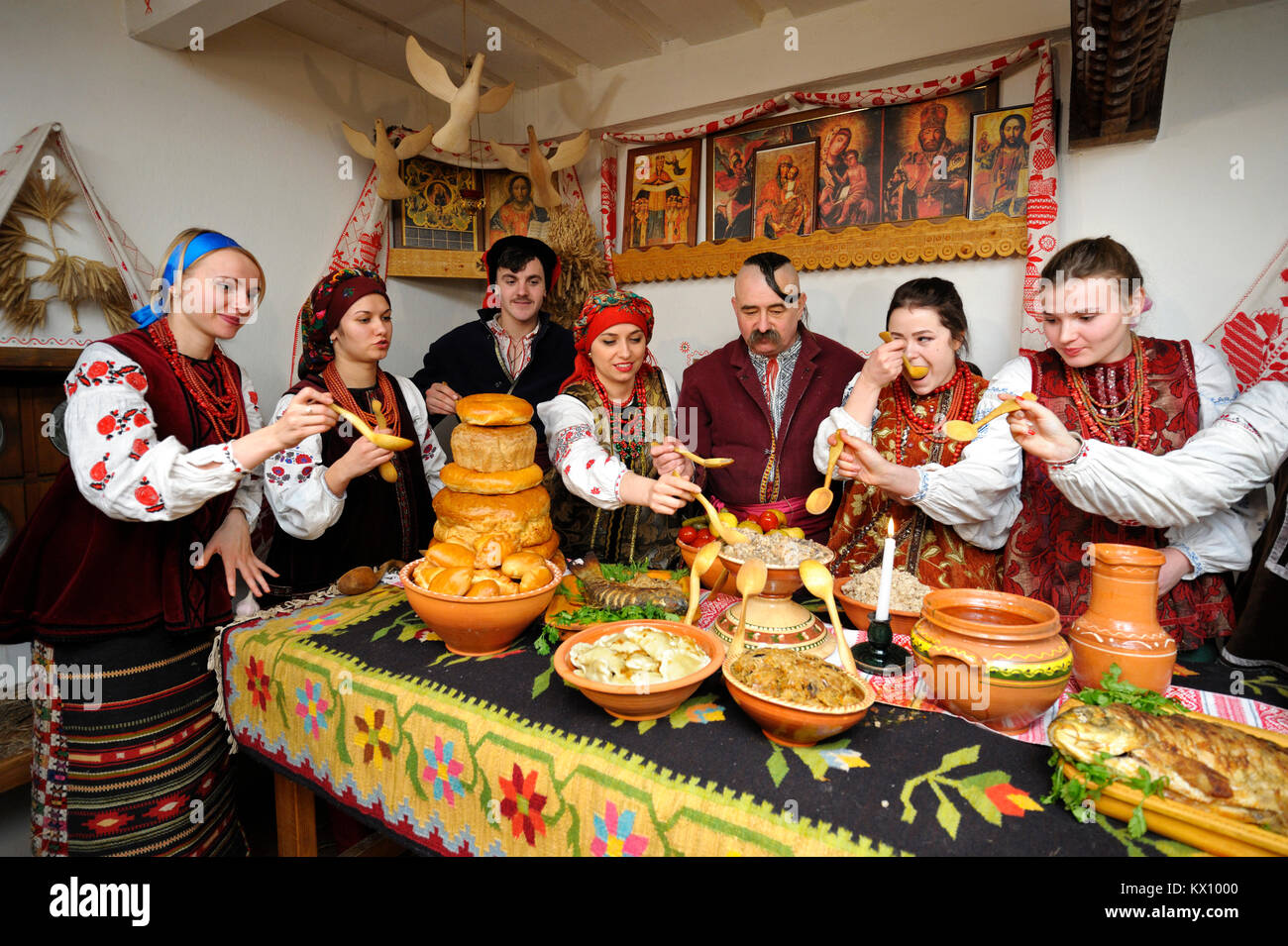 People in Ukrainian native dresses standing behind table to celebrate ...