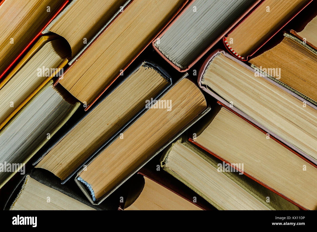 a stack of colorful books in a library or a room Stock Photo - Alamy