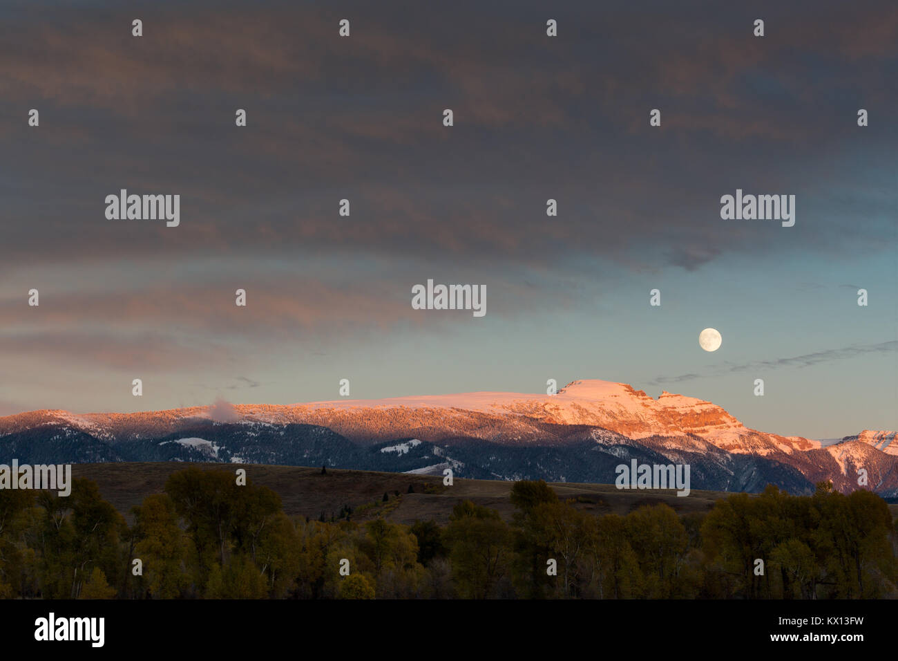 The moon rising above the Sleeping Indian at sunset as light storm ...