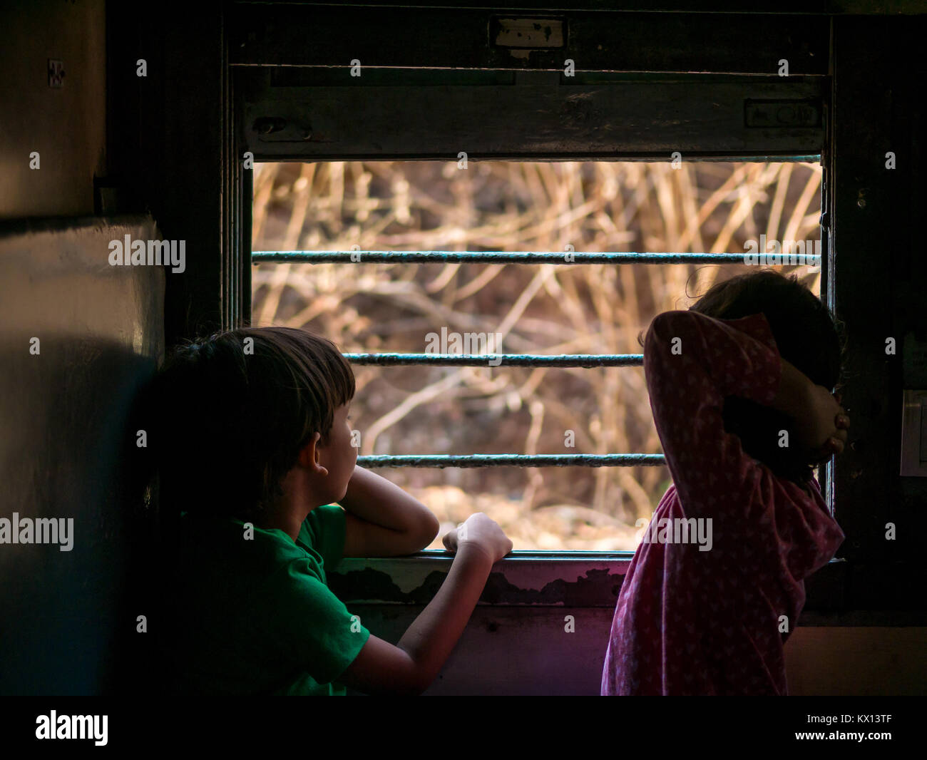 Mumbai, India - December 18, 2017 : Kids looking outside train window ...