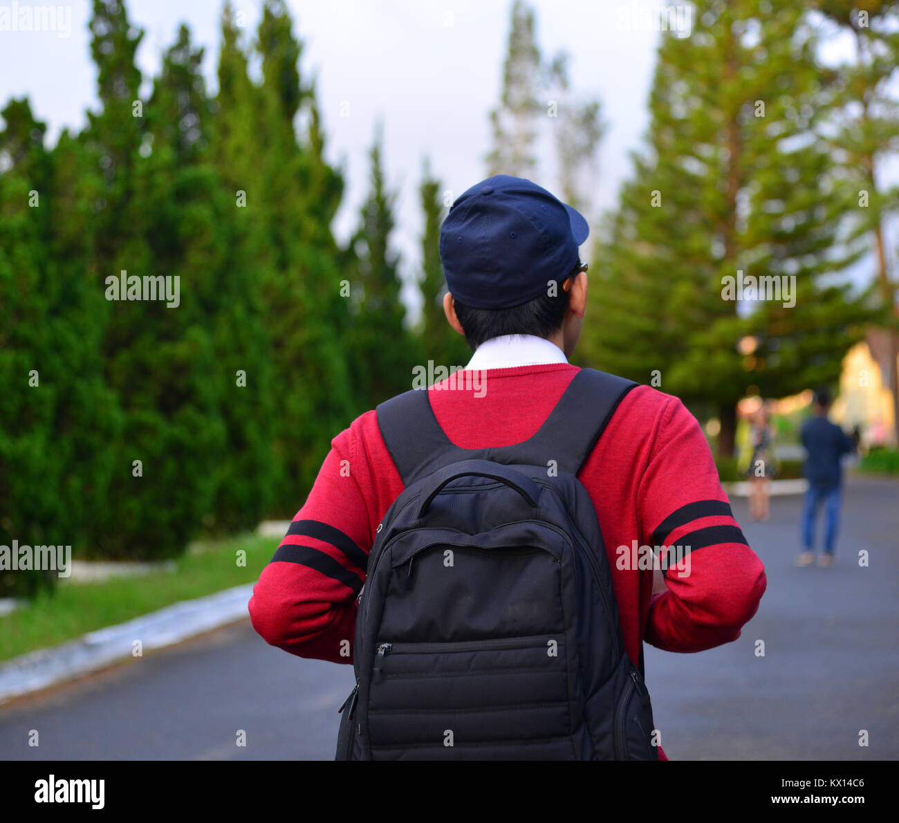 A young student with backpack walking at an old college Stock Photo - Alamy