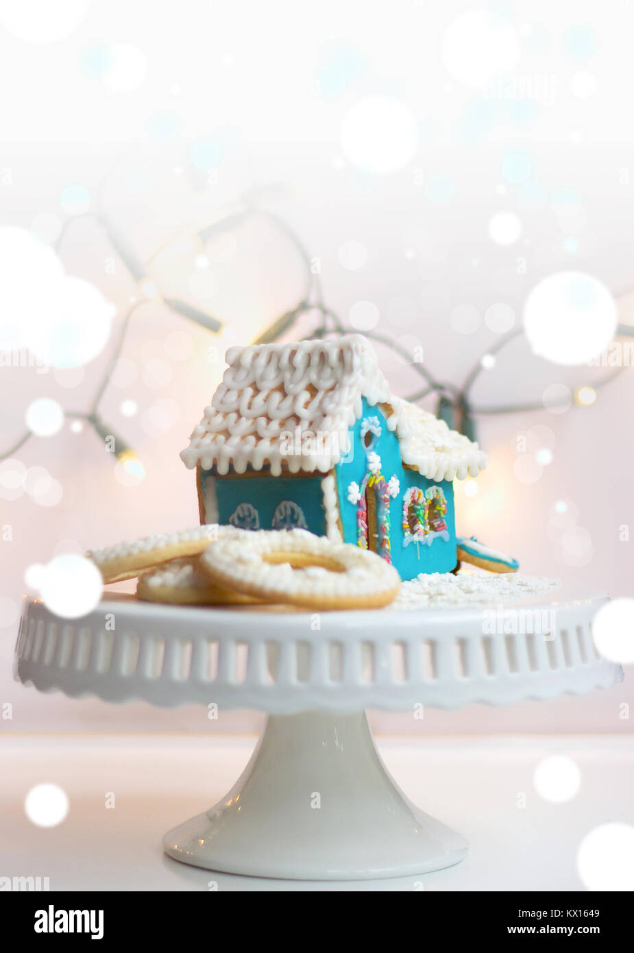 Blue homemade gingerbread house cookie on white background with copy ...
