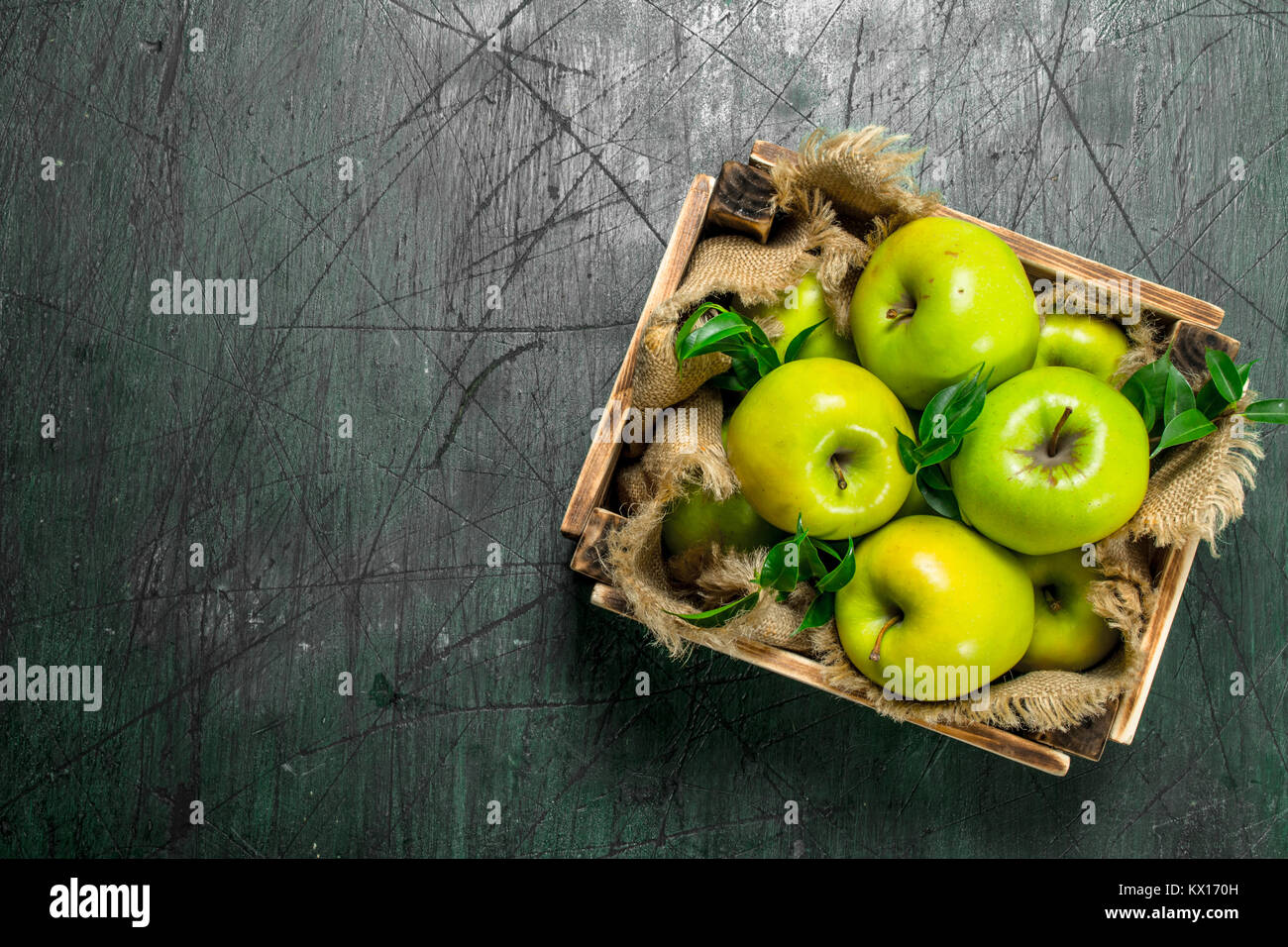 Green apples in an old box. On a rustic background Stock Photo - Alamy