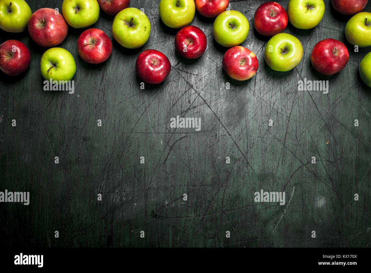 Red and green apples. On a rustic background Stock Photo - Alamy