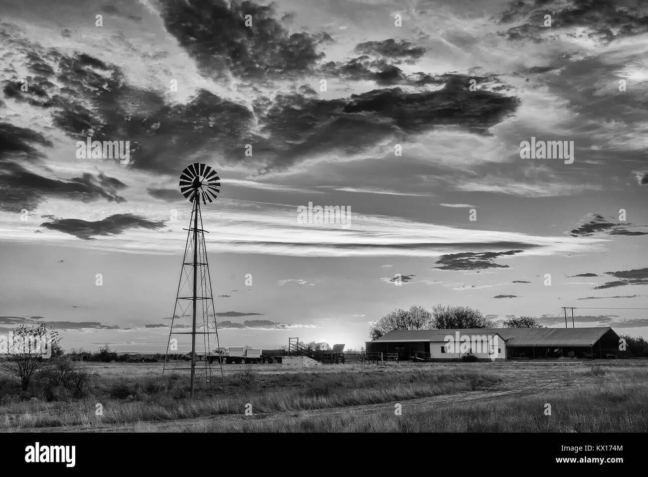 A water-pumping windmill at sunset on a farm near Ritchie in the ...